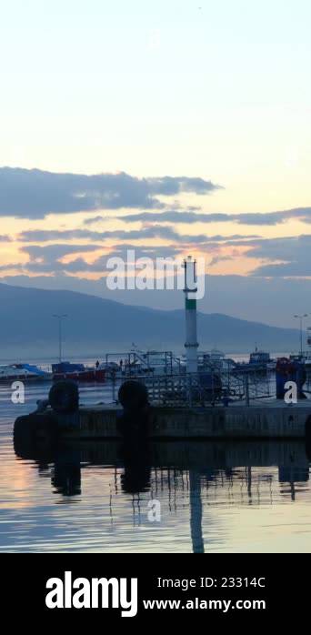 Ferry approaching the ship pier in the afternoon, people work and ...