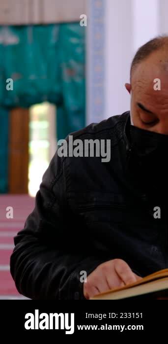 Shot of mature man reading islam holy book from different angles ...