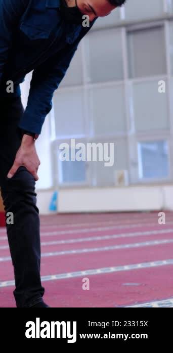 Man with black health mask on his face goes to prostration while ...