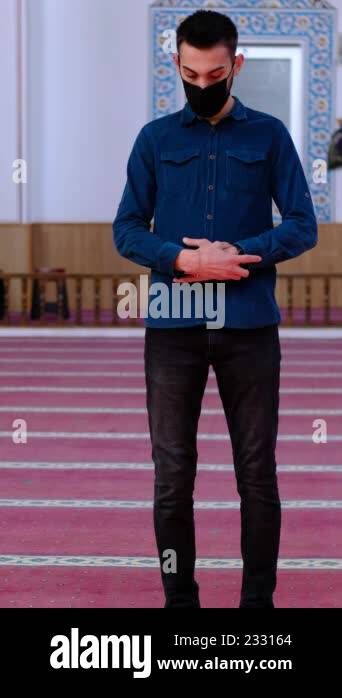 Young man in mask worshiping mosque from different angles, Muslim men ...