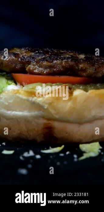 Slow motion shot of layered hamburger making, burger menu image with ...