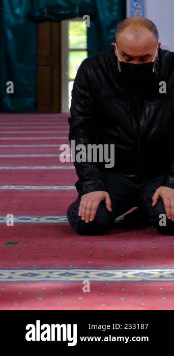 The man ends the prayer by turning his head to the right and left, a ...