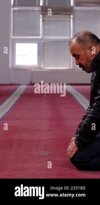 A mature man praying sitting in the mosque, Muslim men go to the mosque ...