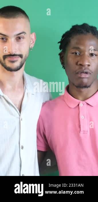 Two men making peace sign with hands together, male models posing for ...