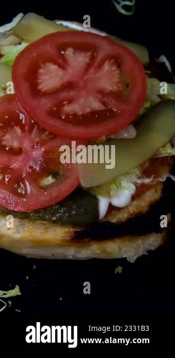 Slow motion shot of layered hamburger making, burger menu image with ...