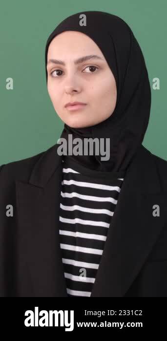 Muslim teenager woman sign nod, hijab girl point out in front of green ...