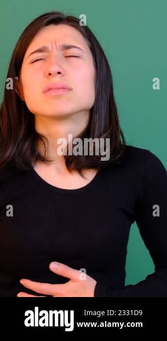 Woman stomach very sick and ache in front of green screen, girl is a ...