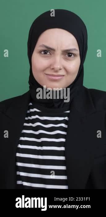 Muslim girl waving hand bye bye, young person dont know sign in front ...