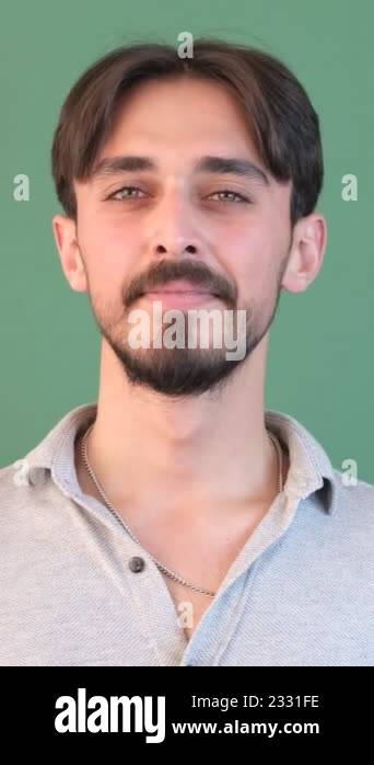 Bearded man kissing his own hand in green screen, a young romantic ...