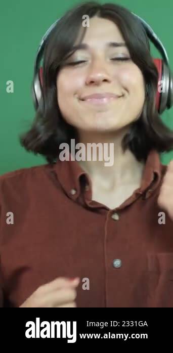 Image of girl listening to music and having fun with red headphones ...