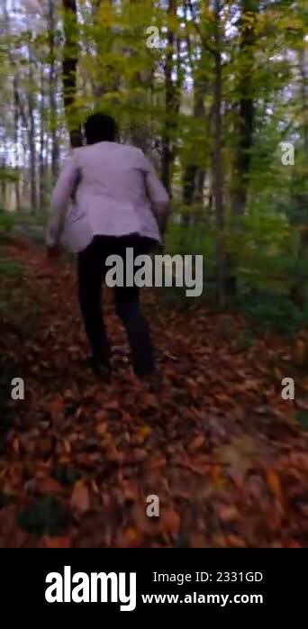 Man running fast through the deserted forest, teenager running away on ...