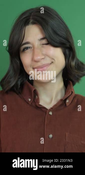 Beautiful girl blinking one eye, using her face in meaningful messages ...