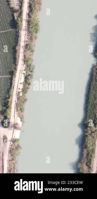 Drone view of the river feeding the natural delta, cultivated green ...