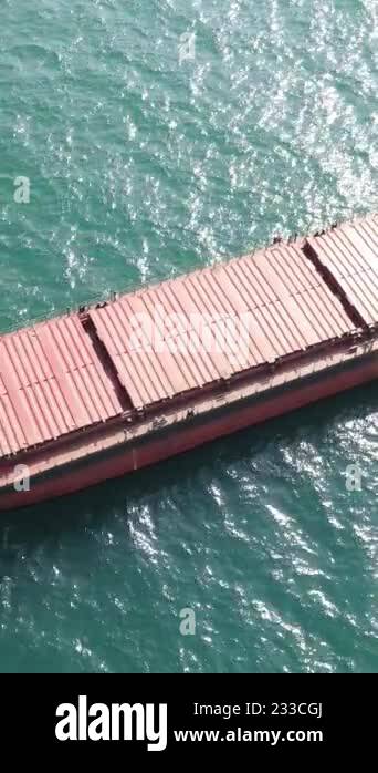 Aerial view of a cargo ship, drone shot cargo ship going on route ...