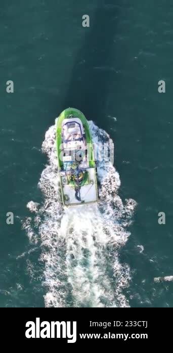 Drone view of small ship foaming in the sea, fishing boat fishing from ...