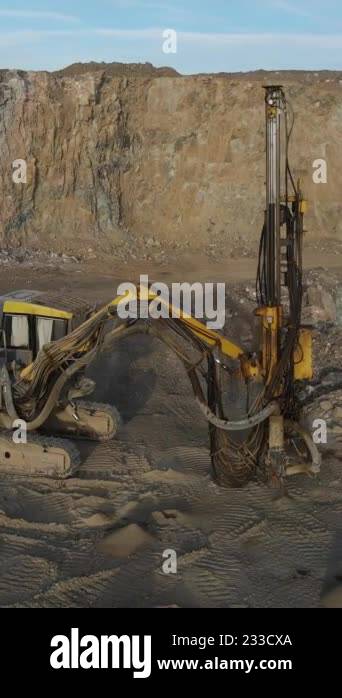 Aerial drone view of the earthwork site of excavator, a pile of earth ...