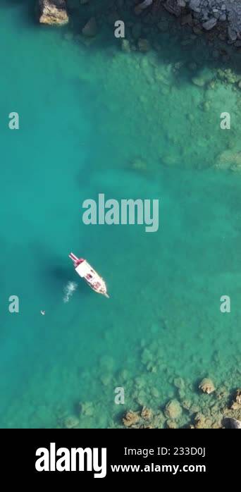 Aerial view sea cove, Boats moored in a small bay and people swimming ...