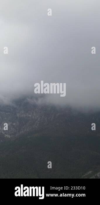 Drone view of dense fog cloud on top of high mountains, mist cloud in ...