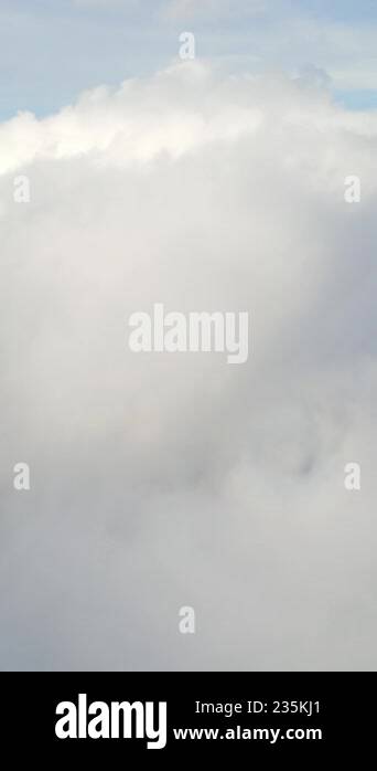 White and blue soft cumulus clouds in the sky close-up background, big fluffy cloud texture ...