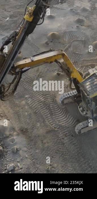 Aerial drone view of the earthwork site of excavator, a pile of earth ...