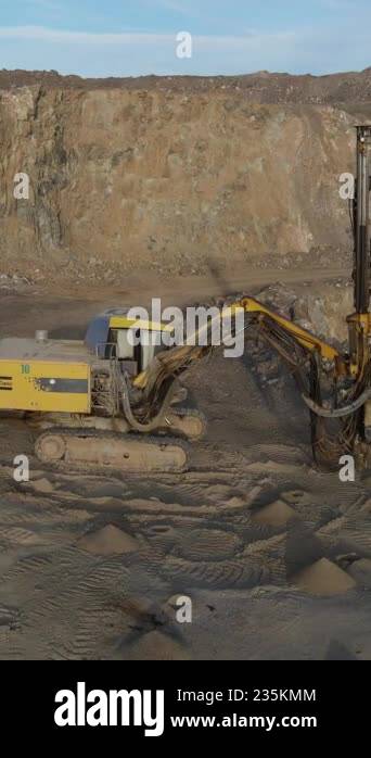 Aerial drone view of the earthwork site of excavator, a pile of earth ...