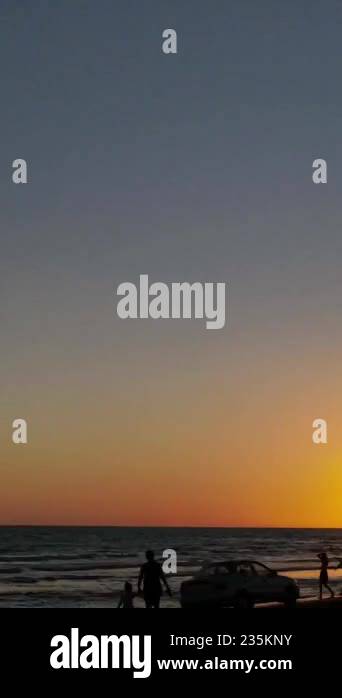 Time lapse sunset, time lapse fast movement of people on the beach at ...