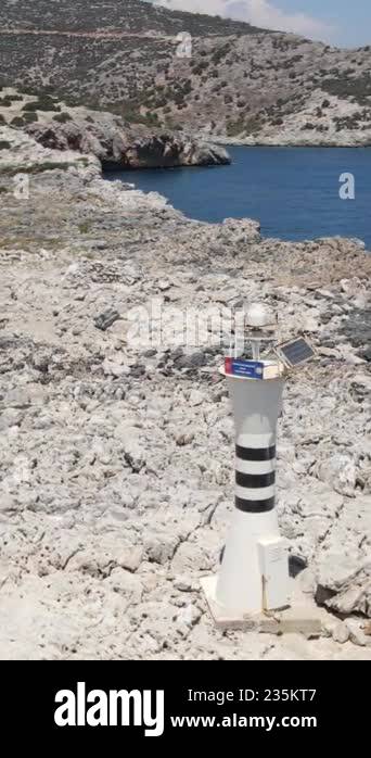 Lighthouse at edge of coast, lighthouse tower perched on the shore of ...