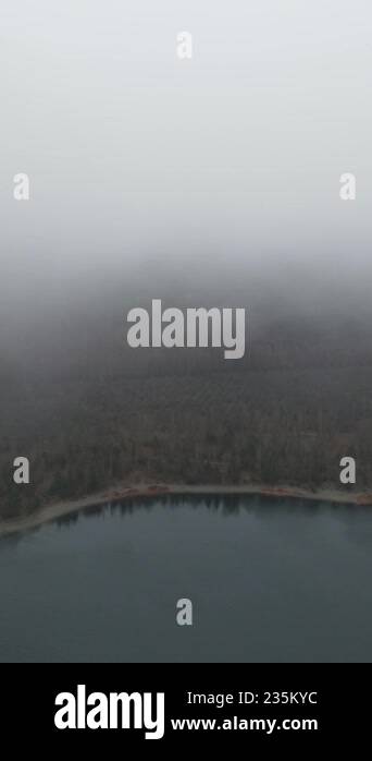 Drone view through foggy weather cloud, cold and thick fog mist over ...
