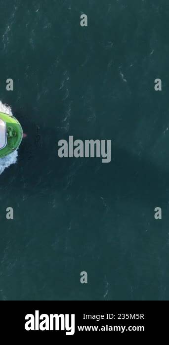 Drone view of small ship foaming in the sea, fishing boat fishing from ...