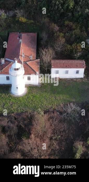 Drone view of the lighthouse in the trees, the white lighthouse ...