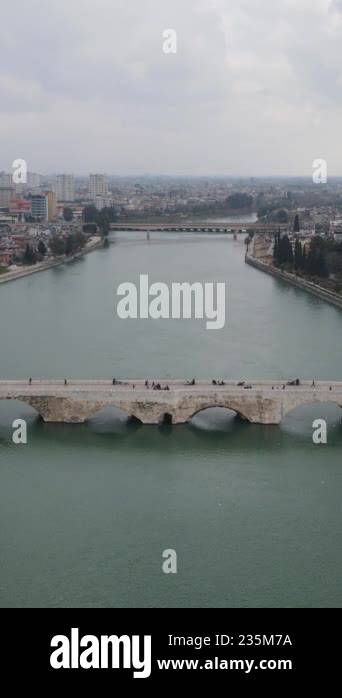 Aerial view of Adana Stone Bridge, drone shot people use historical ...