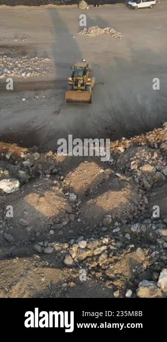 Working view of the dozer carrying the stacked soils, aerial view of ...