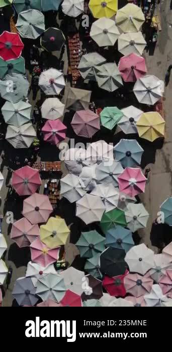 Drone footage of shopping markets set up on the street, street shopping covered with umbrellas ...