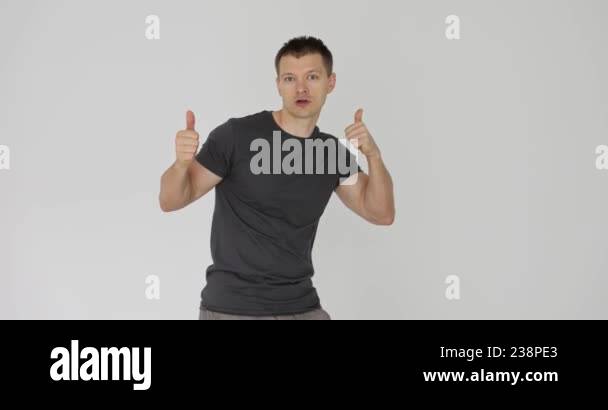 Enthusiastic dancing man showing thumb up on white background. Happy ...