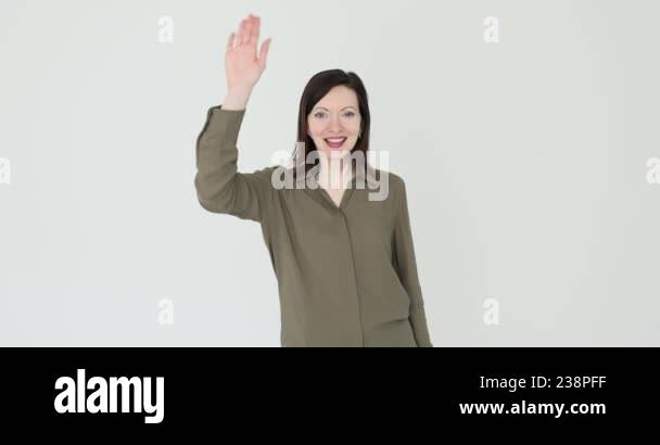 Woman showing friendly hand wave on white background. Gesture of ...