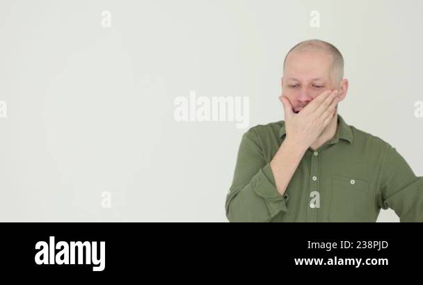 Man yawning and showing signs of fatigue on white background. Emotions ...