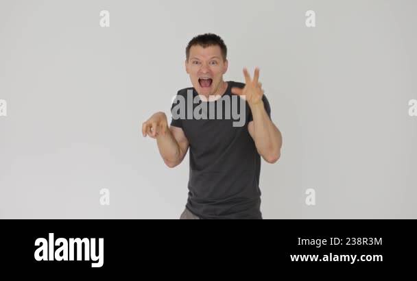 Energetic man performing bizarre dance moves. Man funny grimaces Stock ...