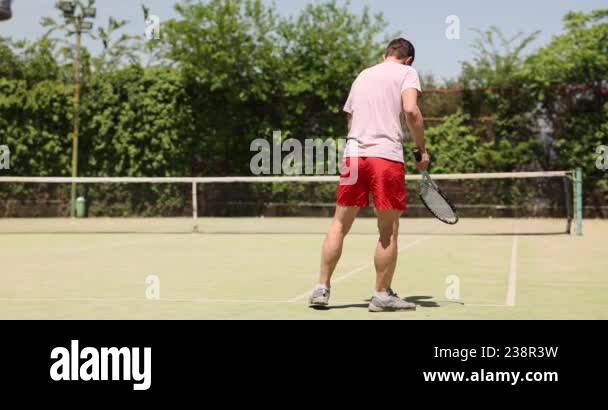 Tennis player practicing on the court on a sunny day. Athlete foot on ...