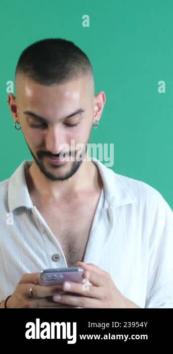 Male model texting on the phone with a smile, spending happy time with ...