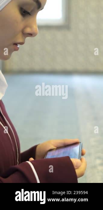 Women Pray From Digital Quran, muslim hijab girl following the quran on ...