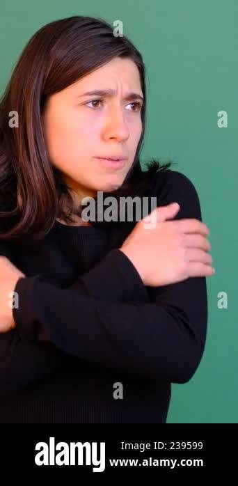 Very cold freezing girl in front of isolated green background, this ...
