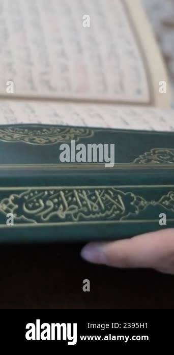 Opening the Quran on the wooden lectern and starting to read, the ...