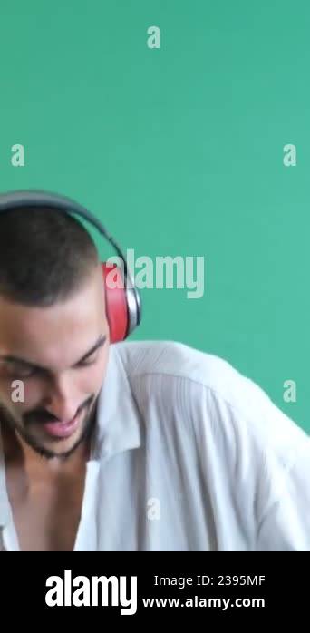 Man dancing with enjoyment and listening to music with red headphones ...