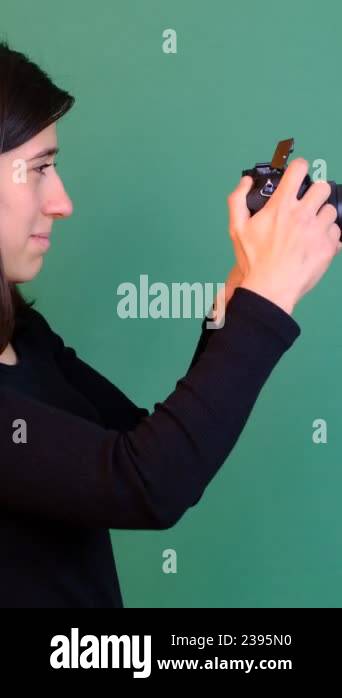Woman with camera taking pictures, girl photographer in front of green ...