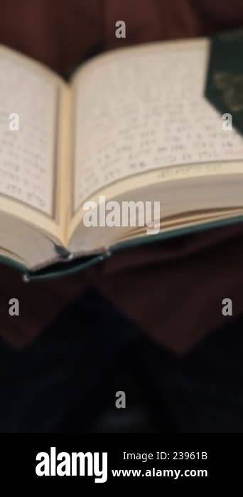 Open the Quran in your hand and start reading it, turn the pages of the ...