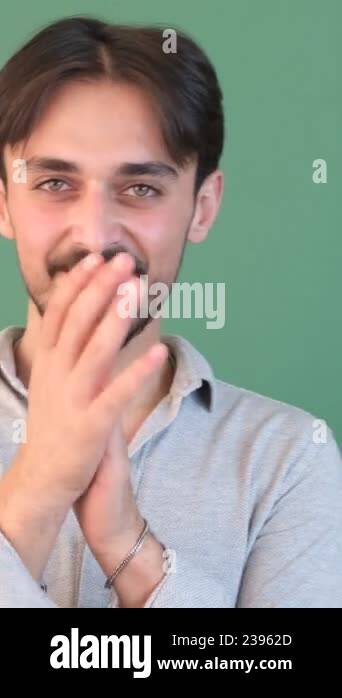 Man gestures happy and rubbing hand green screen, handsome young guy ...