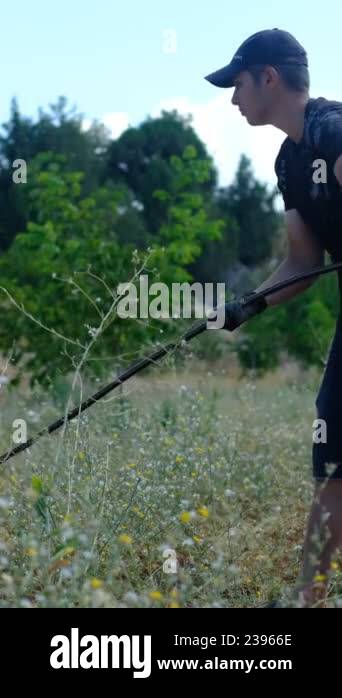Young farmer collection drip pipe, man working in the garden, man ...