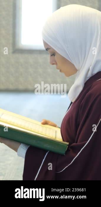 Girl Reciting Quran, young girl sitting on the floor reading the quran ...