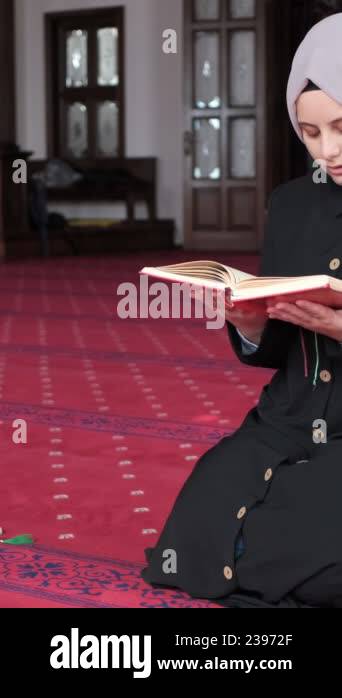 Young muslim woman reading the quran inside the mosque, reciting al ...