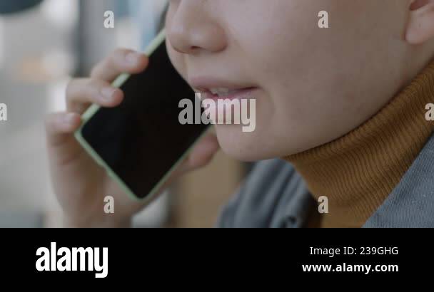 Close-up of man speaking on mobile phone holding modern smartphone ...